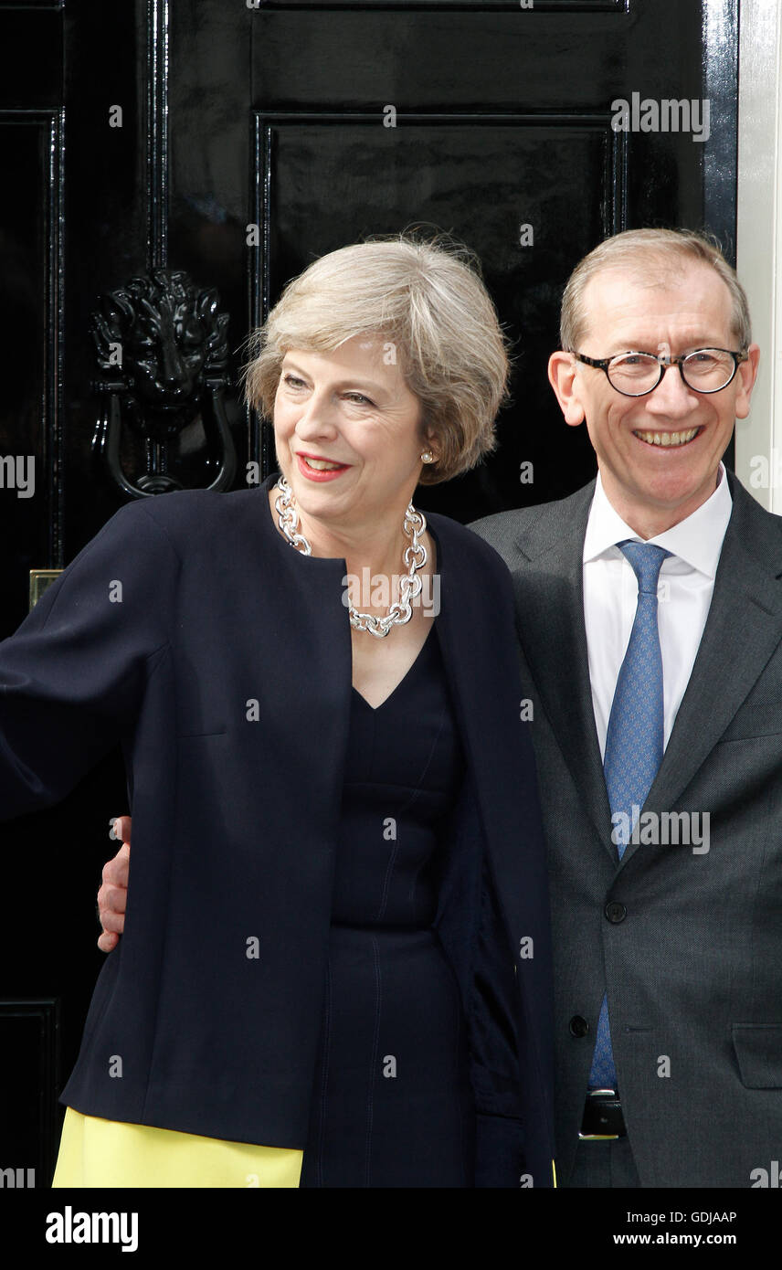 Theresa May and her husband Philip gesture for the media outside the ...