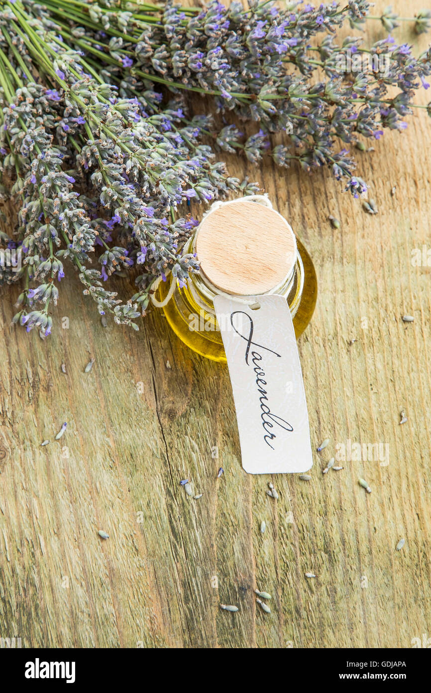Lavender oil with lavender flowers and label on rustic background Stock ...