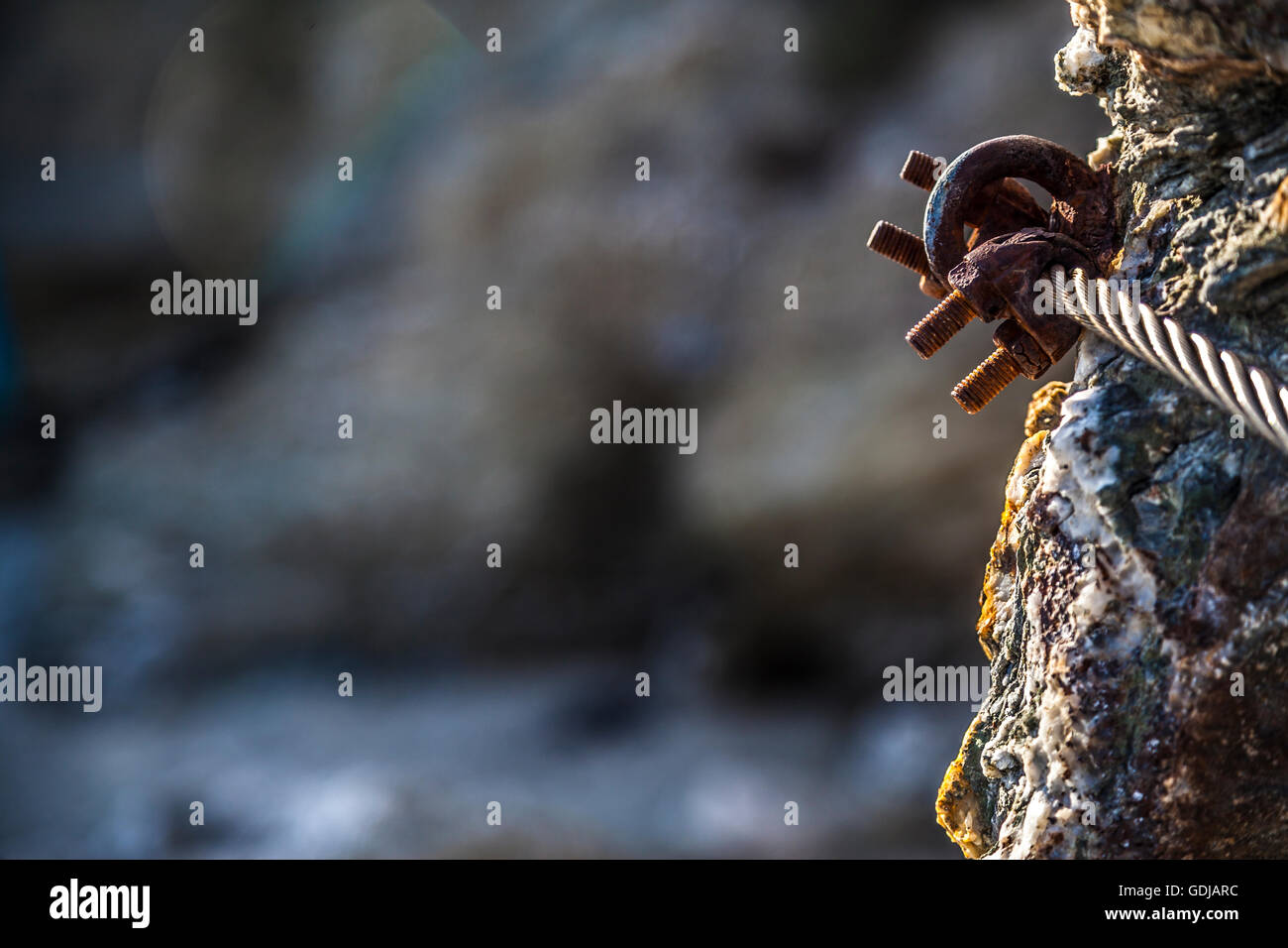 Rusty hook on sea rocks at french riviera Stock Photo - Alamy