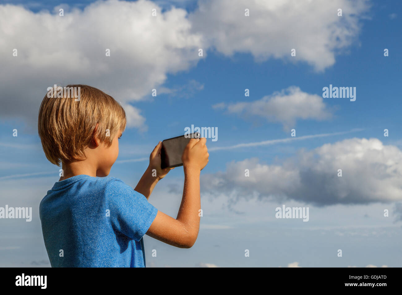 Boy using mobile phone. Child taking photo with his phone. Beautiful ...