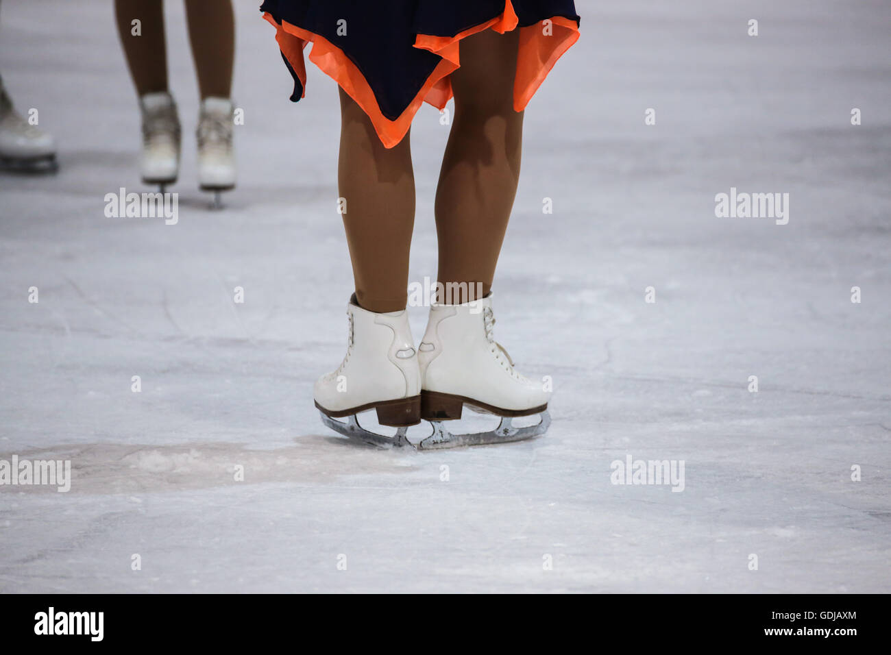 The legs of a skater and their shadow reflected on the ice Stock Photo ...