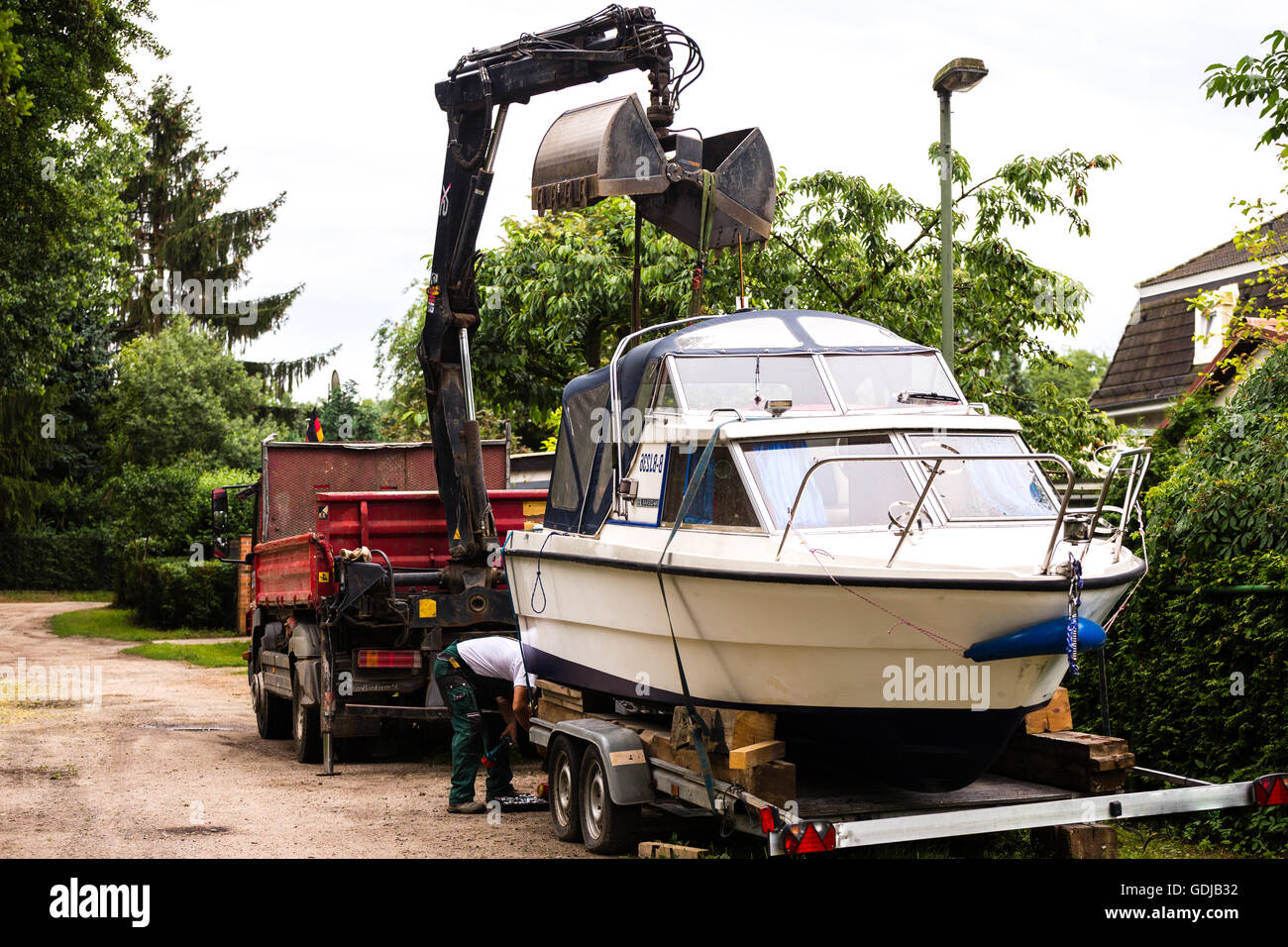 semi boat loading for transport on transporter van truck Stock Photo ...