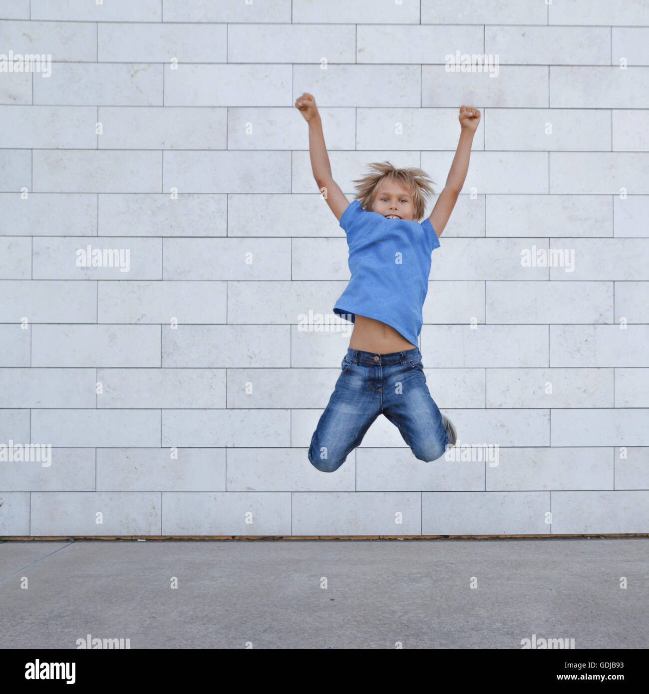 Happy little boy jumping in the city. People, childhood, happiness ...