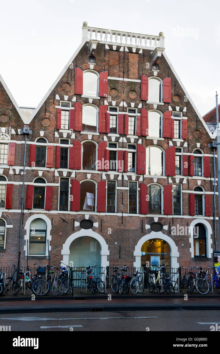 The traditional dutch design building with shutters in Amsterdam ...