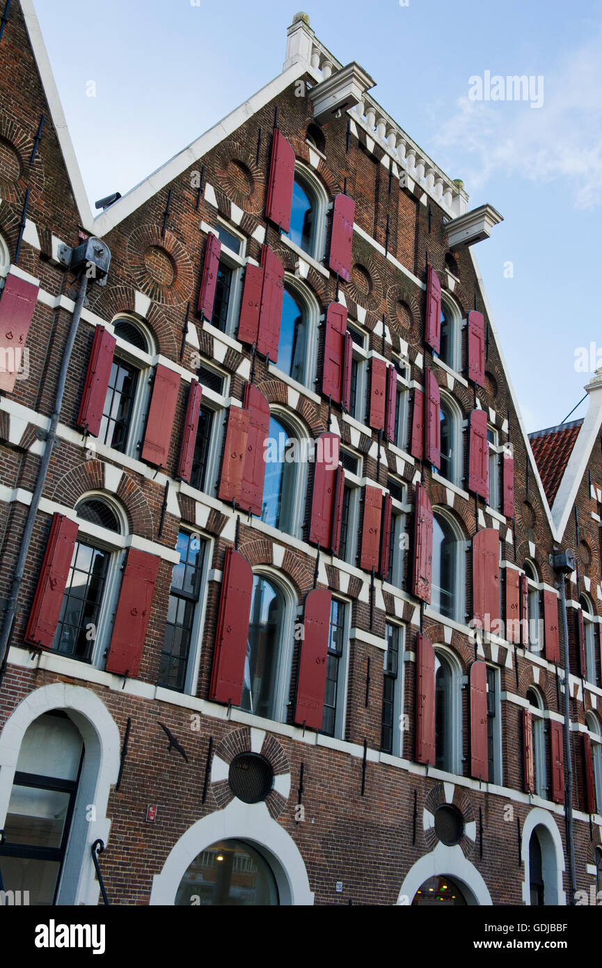 The traditional dutch design building with shutters in Amsterdam ...