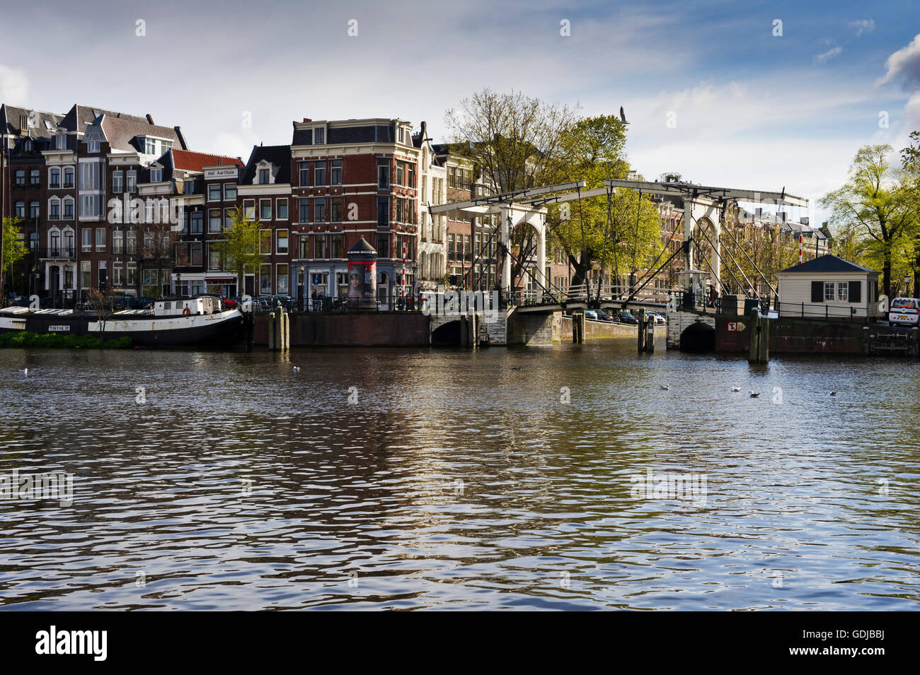 A traditional wooden bridge crossing the canal in Amsterdam, Holland ...