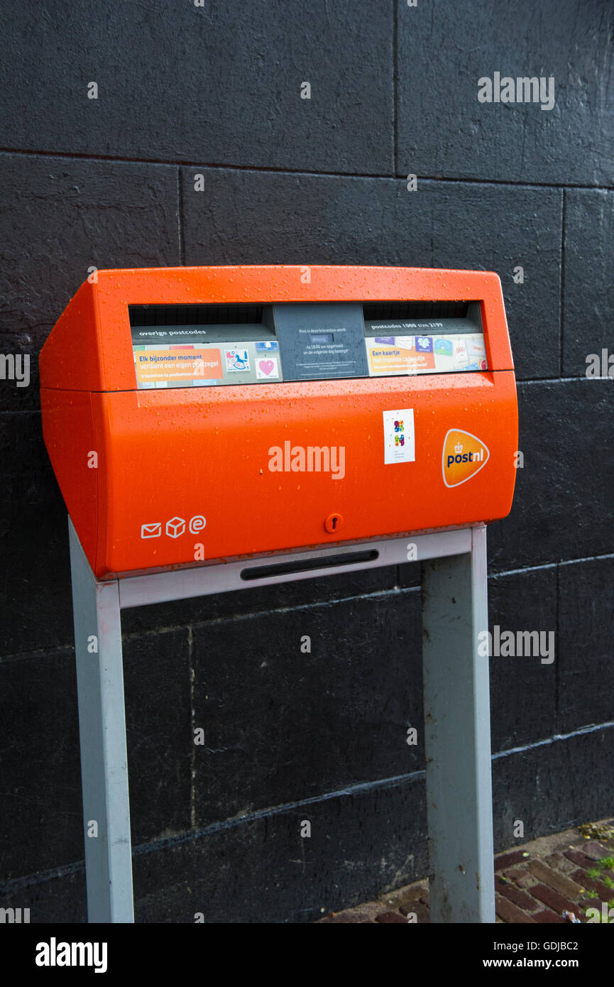 A standing metal red mailbox in Amsterdam, Holland, Netherlands Stock ...