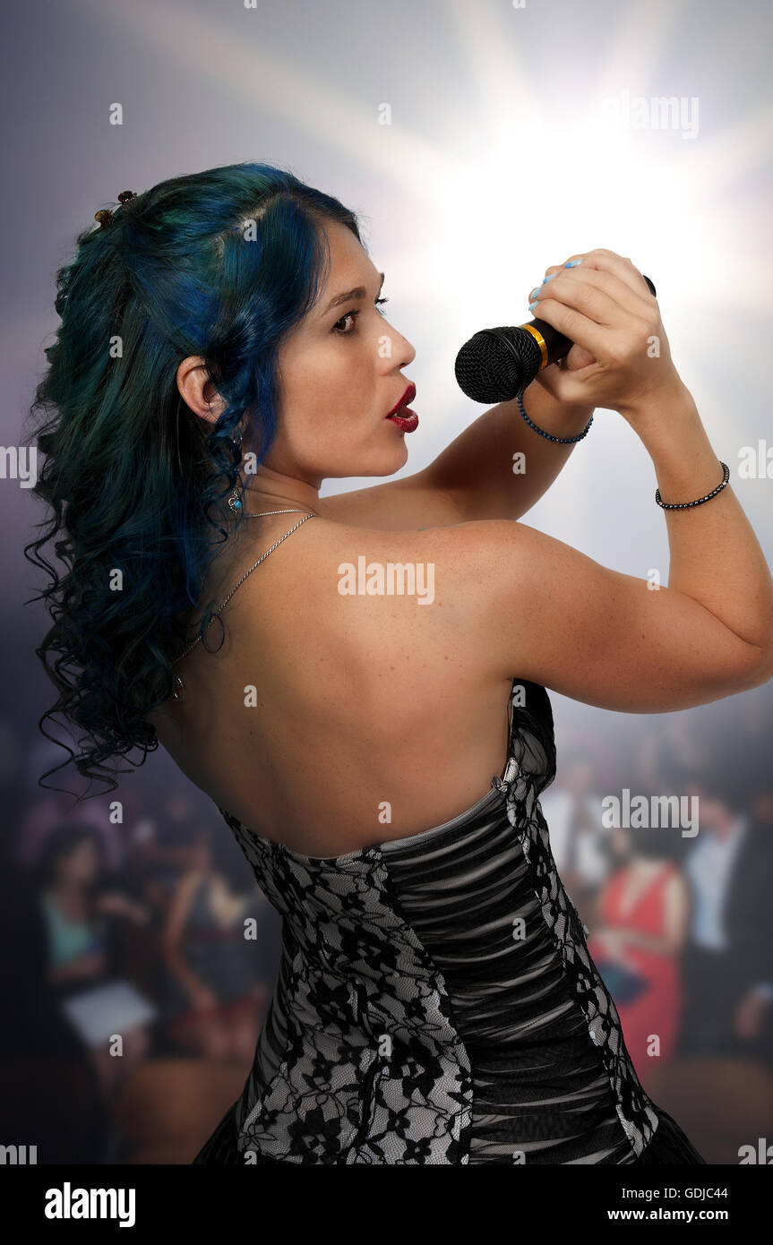 Beautiful woman singer performing at a concert Stock Photo - Alamy