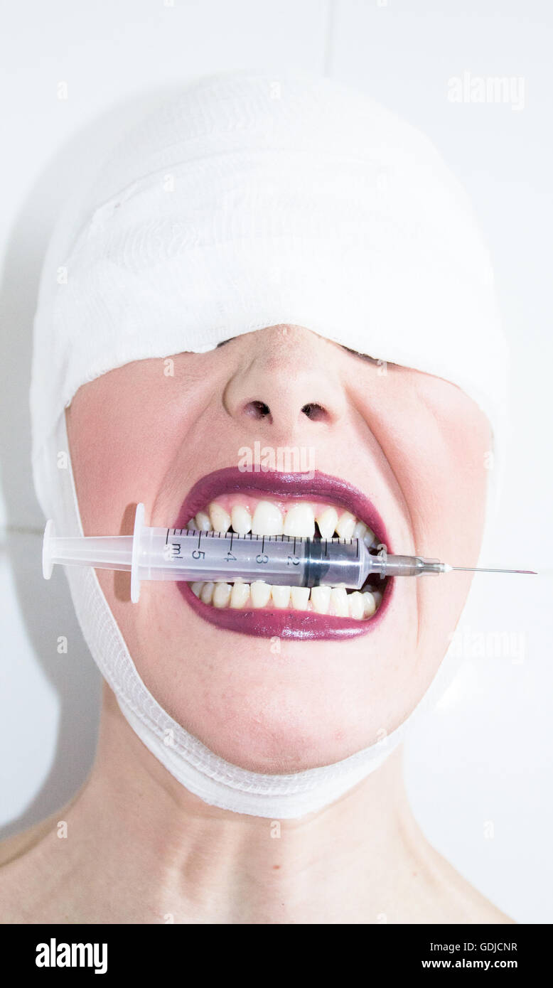 Mental plastic surgery girl eating needle with bandage Stock Photo - Alamy