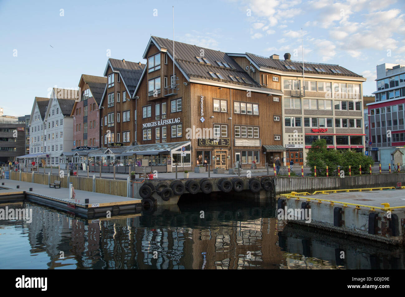 Historic wooden buildings bars and restaurants along harbour waterside ...