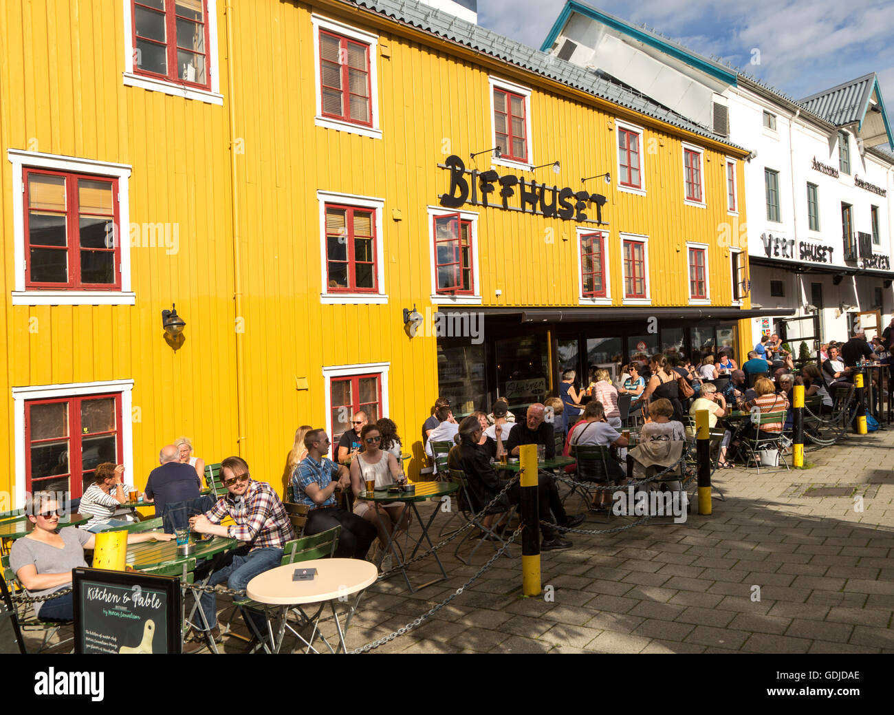 Biffhuset pub with people drinking in summer sunshine outdoors, Tromso ...