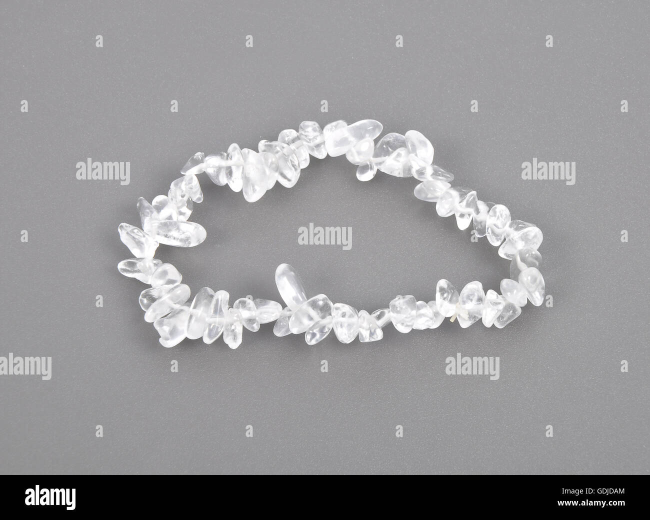 Splintered rock crystal chain on gray background Stock Photo - Alamy