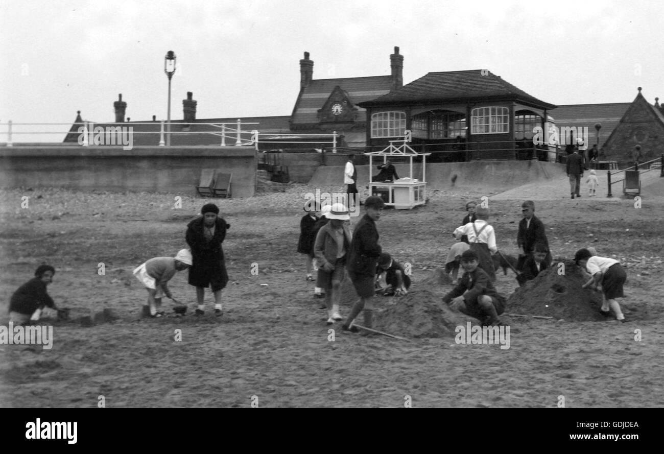 Children playing near the sea front at a seaside town in England c1910 ...