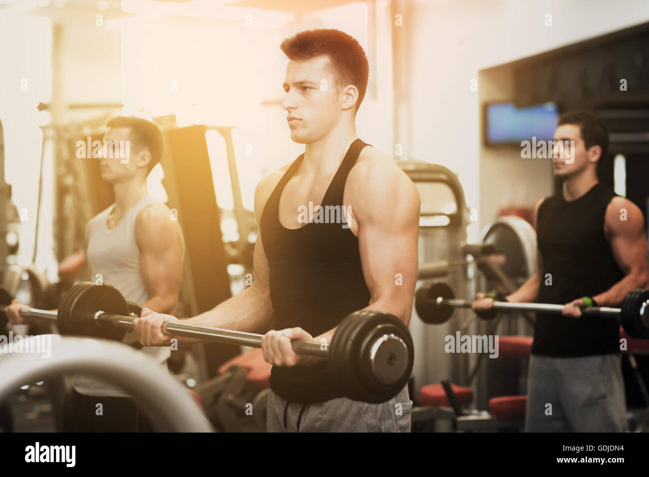 group of men with barbells in gym Stock Photo - Alamy