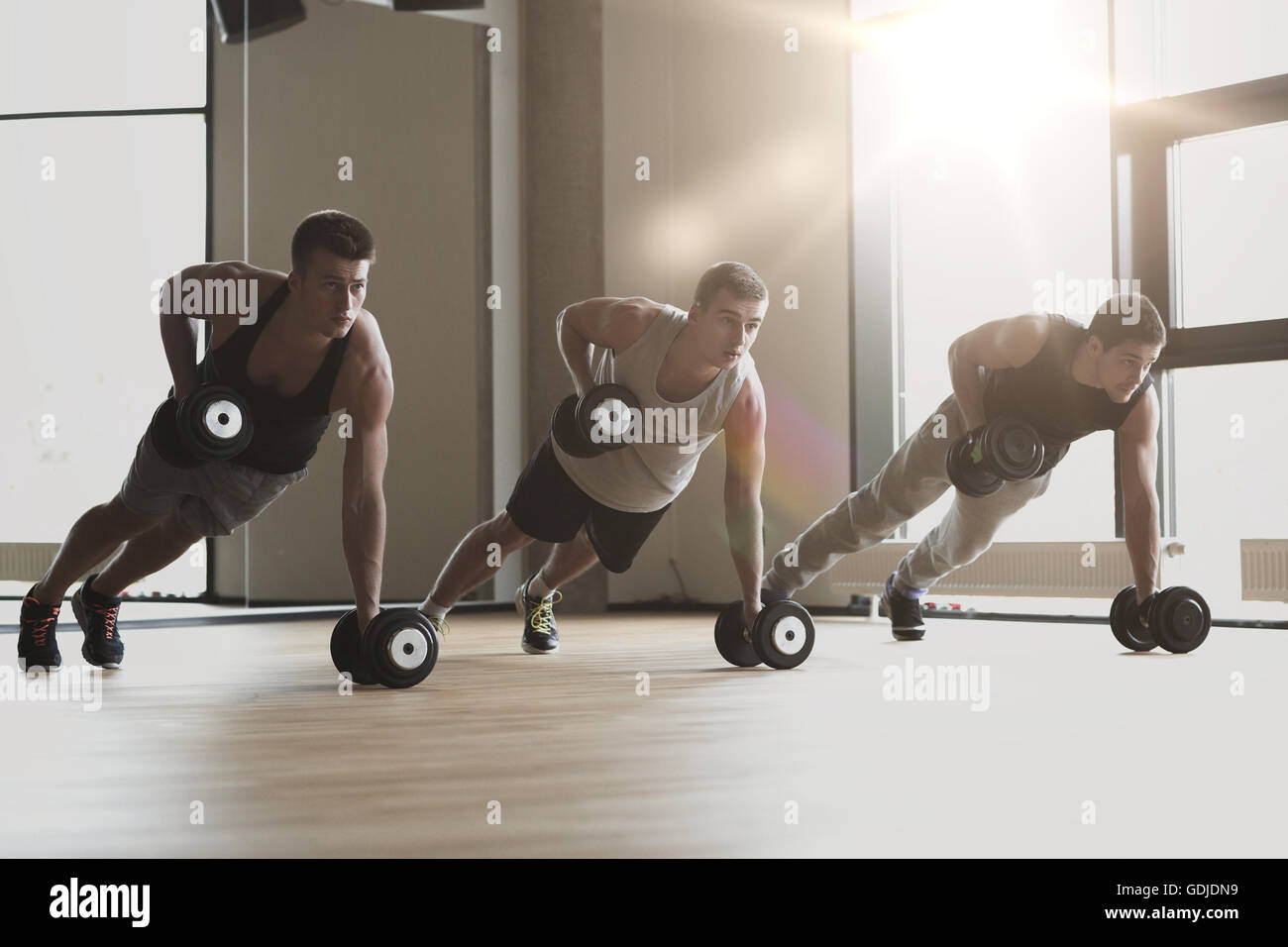 group of men with dumbbells in gym Stock Photo - Alamy
