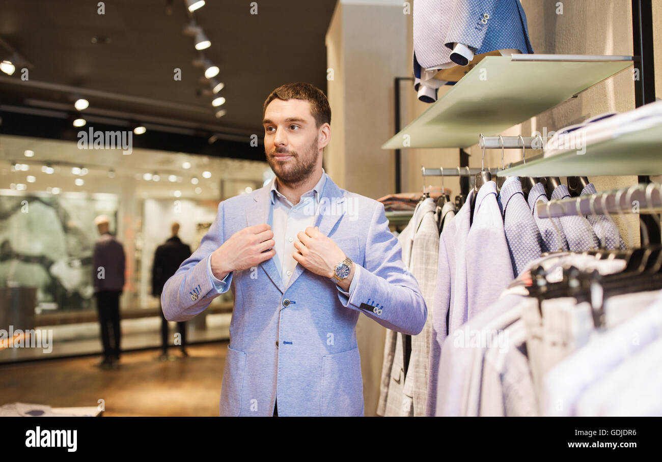 happy young man trying suit at clothing store Stock Photo - Alamy