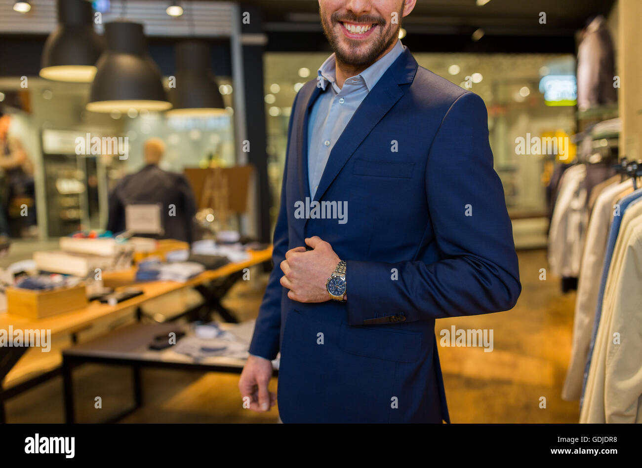 close up of happy man in suit at clothing store Stock Photo - Alamy