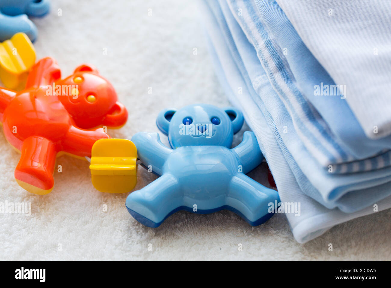 close up of baby rattle and clothes for newborn Stock Photo - Alamy