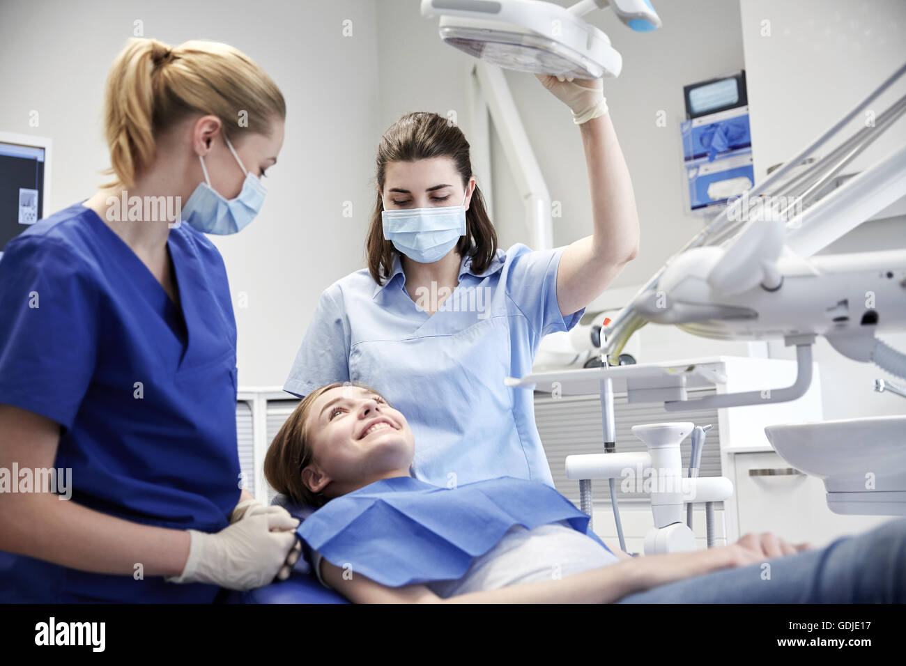 happy female dentist with patient girl at clinic Stock Photo - Alamy