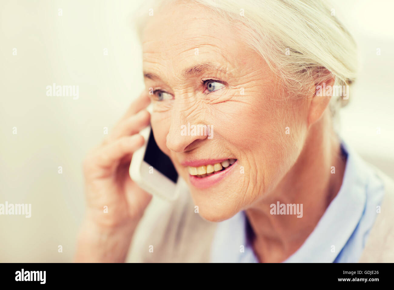 senior woman with smartphone calling at home Stock Photo - Alamy