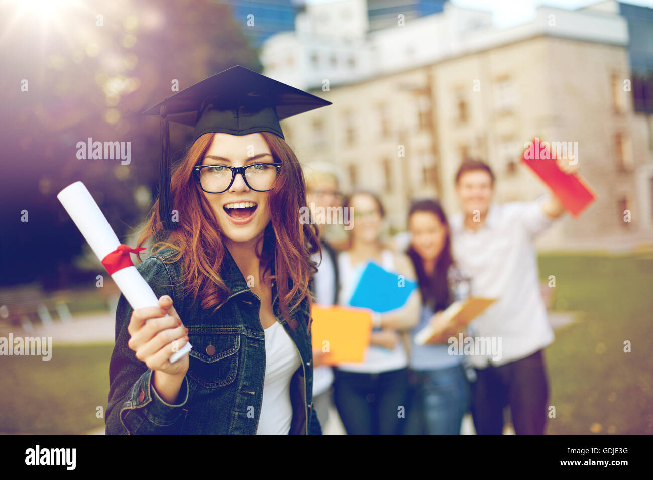 group of smiling students with diploma and folders Stock Photo - Alamy