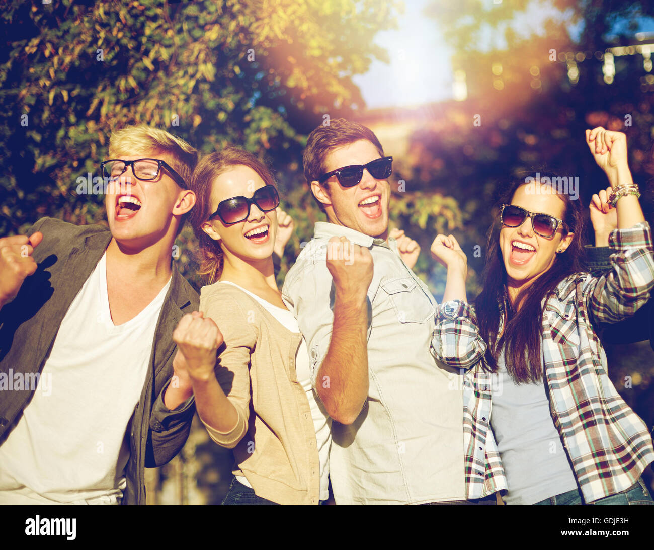group of happy friends showing triumph gesture Stock Photo - Alamy