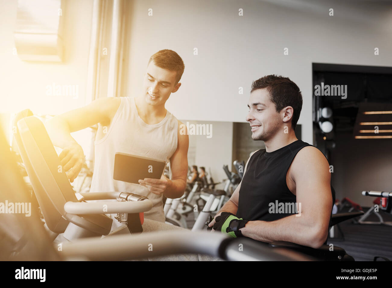 men exercising on gym machine Stock Photo - Alamy