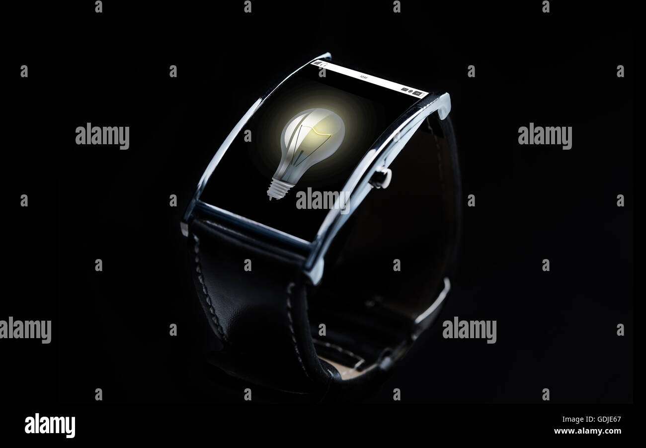 close up of smart watch with light bulb icon Stock Photo - Alamy