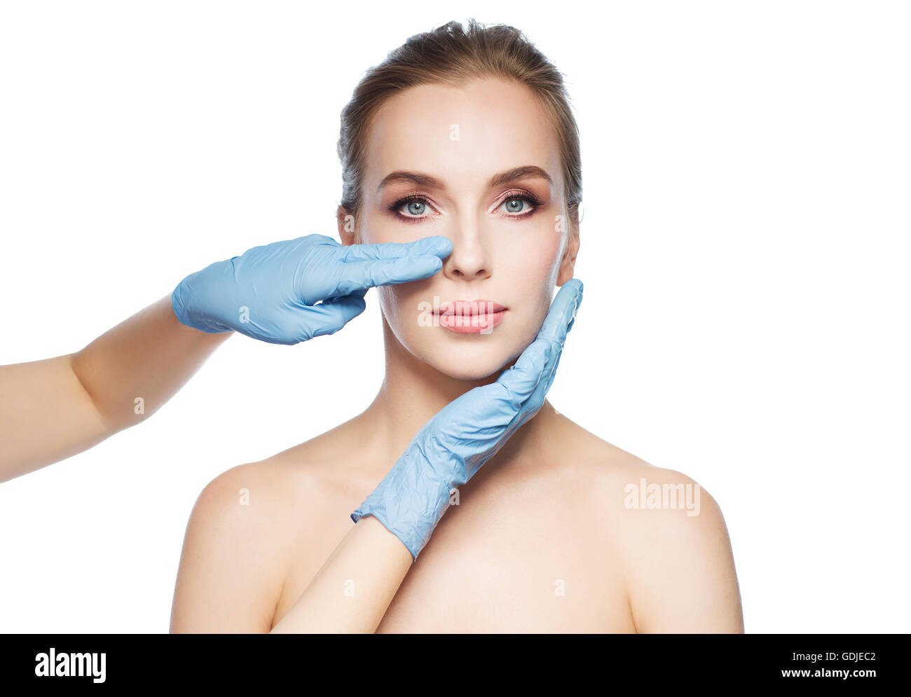 surgeon or beautician hands touching woman face Stock Photo - Alamy