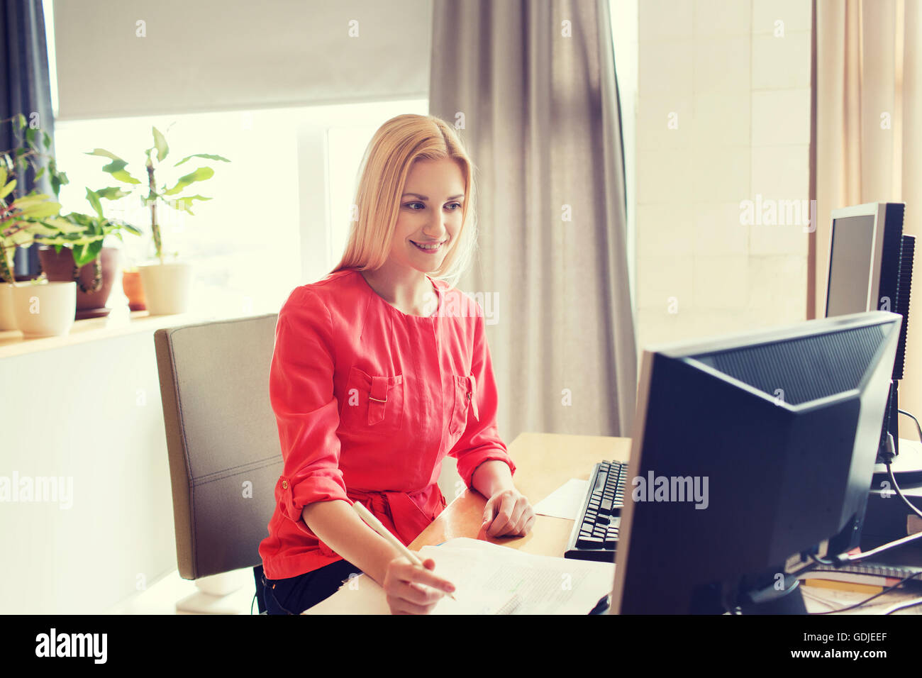 happy creative female office worker with computers Stock Photo - Alamy