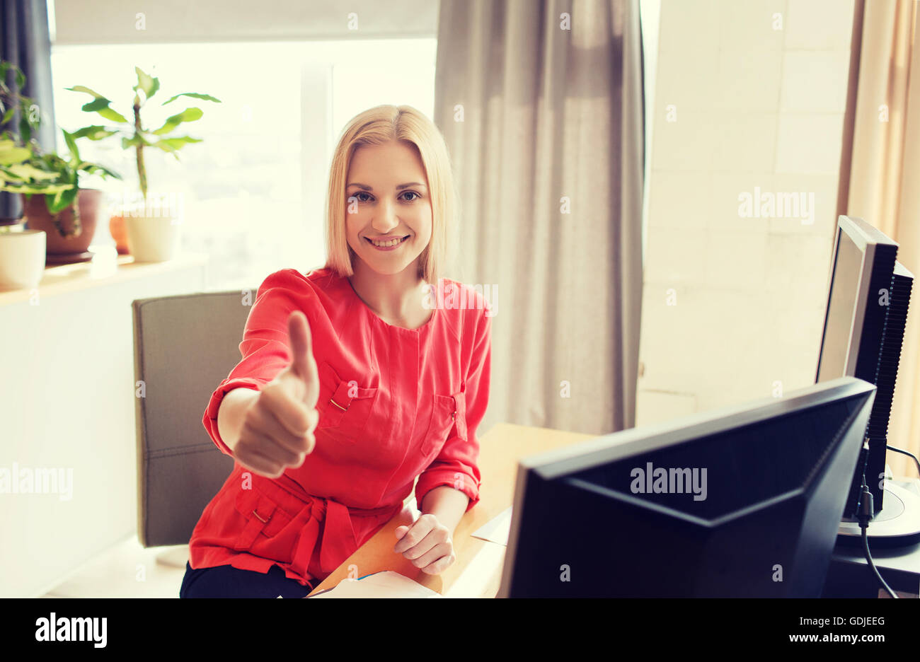 happy creative female office worker with computers Stock Photo - Alamy
