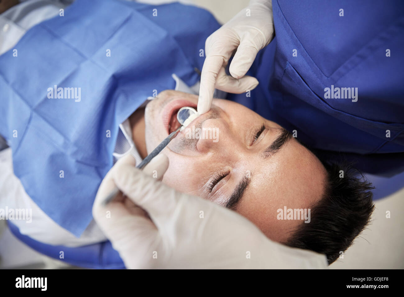 close up of dentist checking male patient teeth Stock Photo - Alamy
