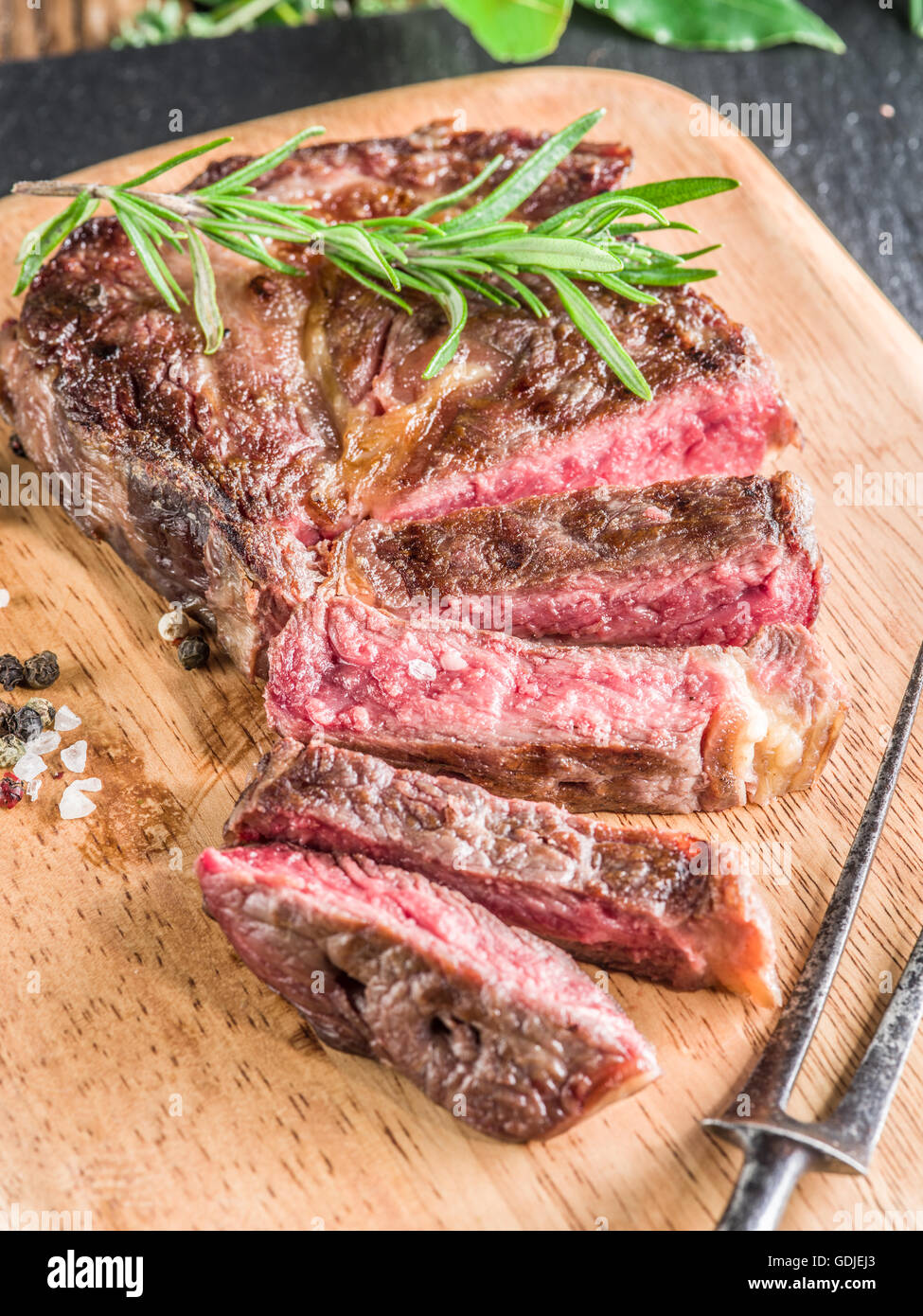 Medium Rib eye steak with spices on the wooden tray Stock Photo - Alamy