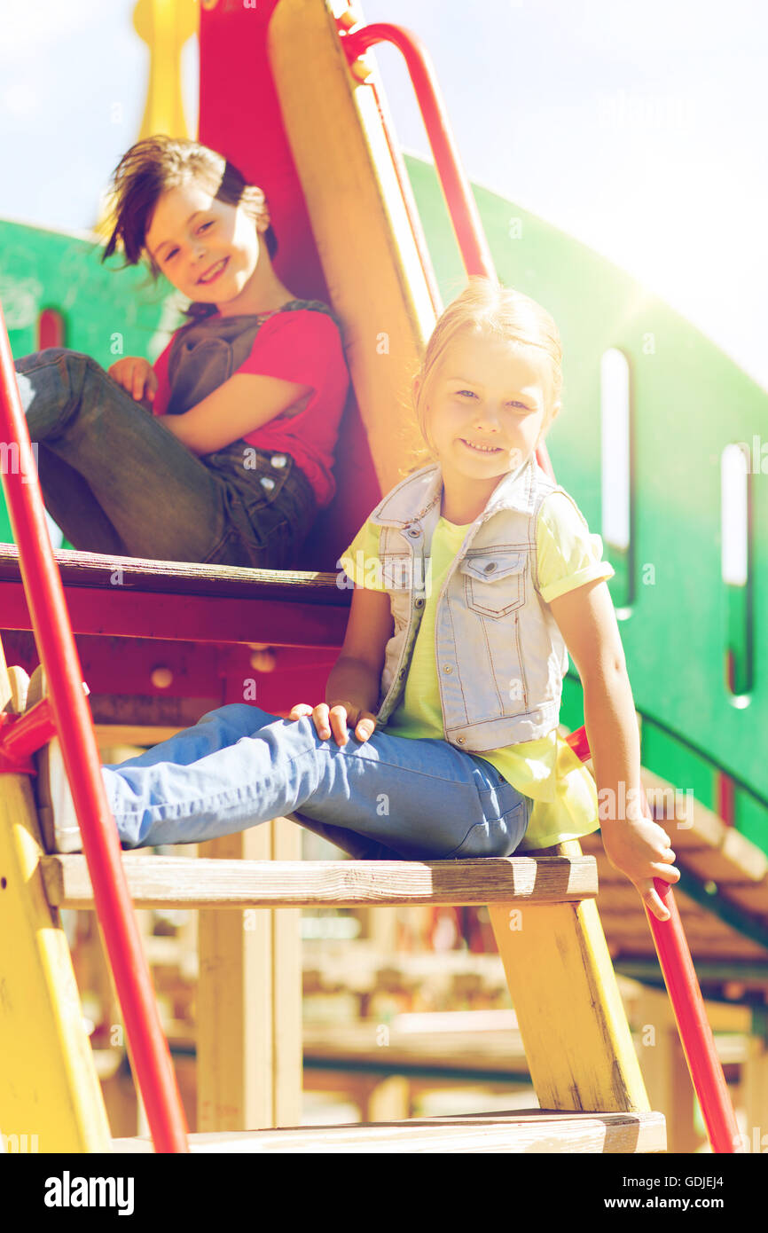 Happy kids playing on slide hi-res stock photography and images - Alamy
