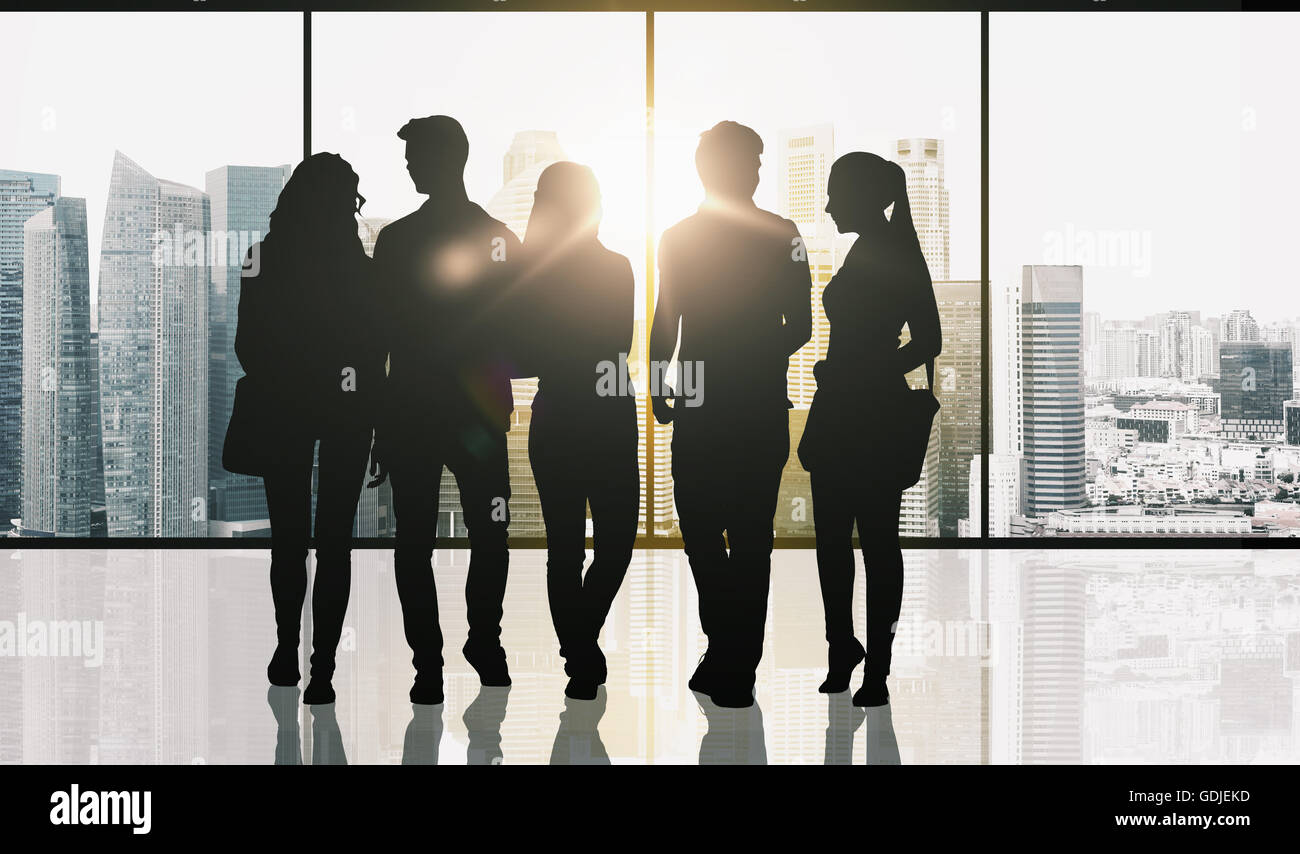 people silhouettes over window and city background Stock Photo - Alamy