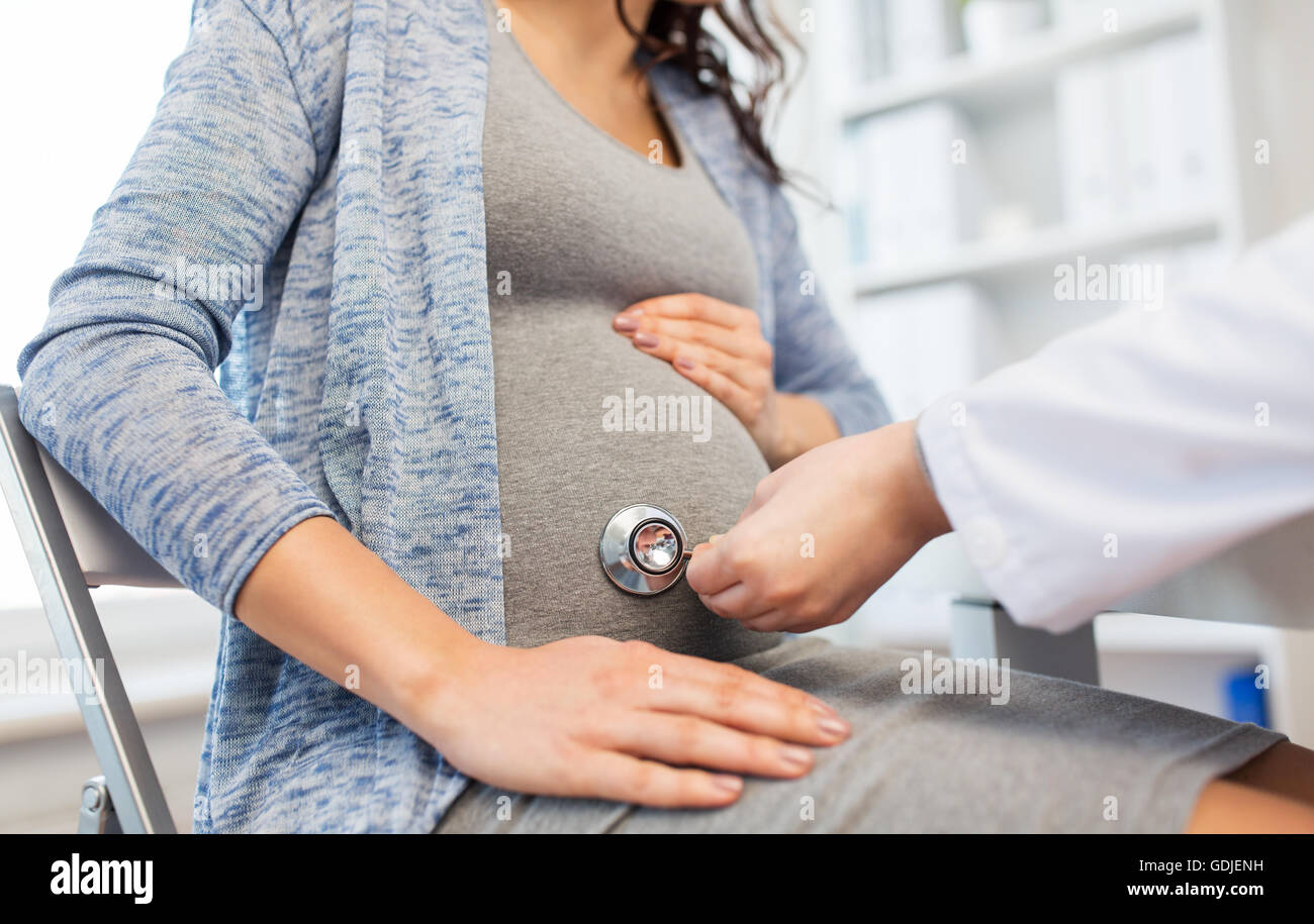 doctor with stethoscope and pregnant woman belly Stock Photo - Alamy