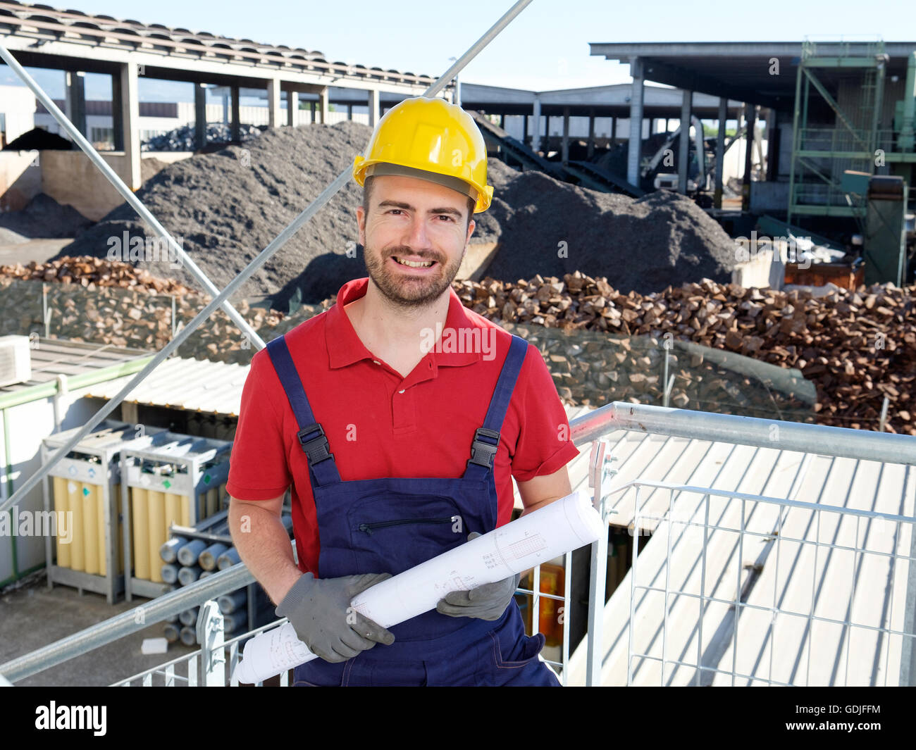 Portrait of factory worker on building site background Stock Photo - Alamy