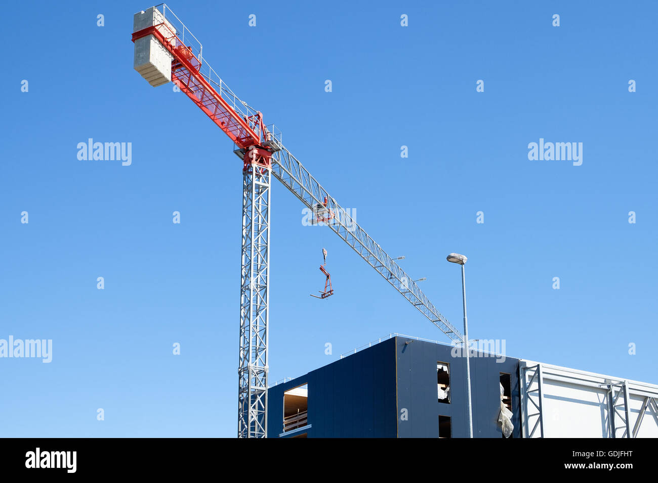 Modern crane in a construction site Stock Photo - Alamy