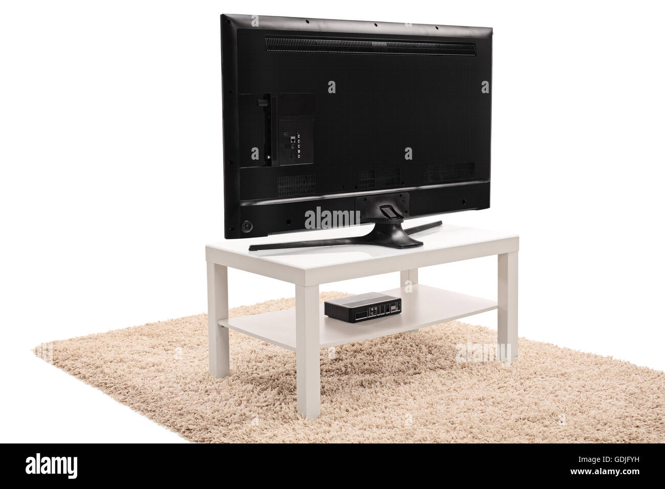 Rear view shot of a modern black flat screen TV on a white wooden TV ...