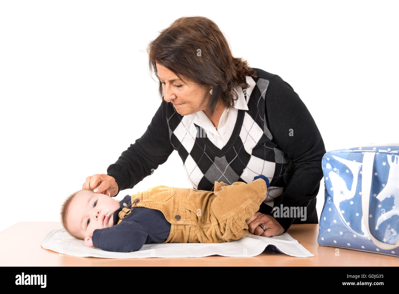 Grandmother changing baby diaper isolated in white Stock Photo - Alamy