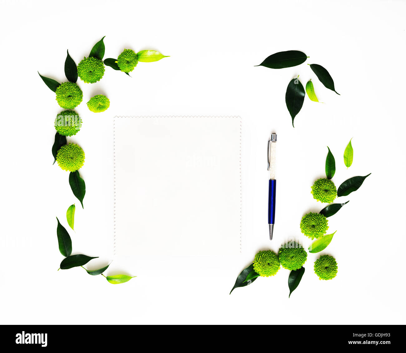 Paper and pen with decoration of chrysanthemum flowers and ficus leaves ...