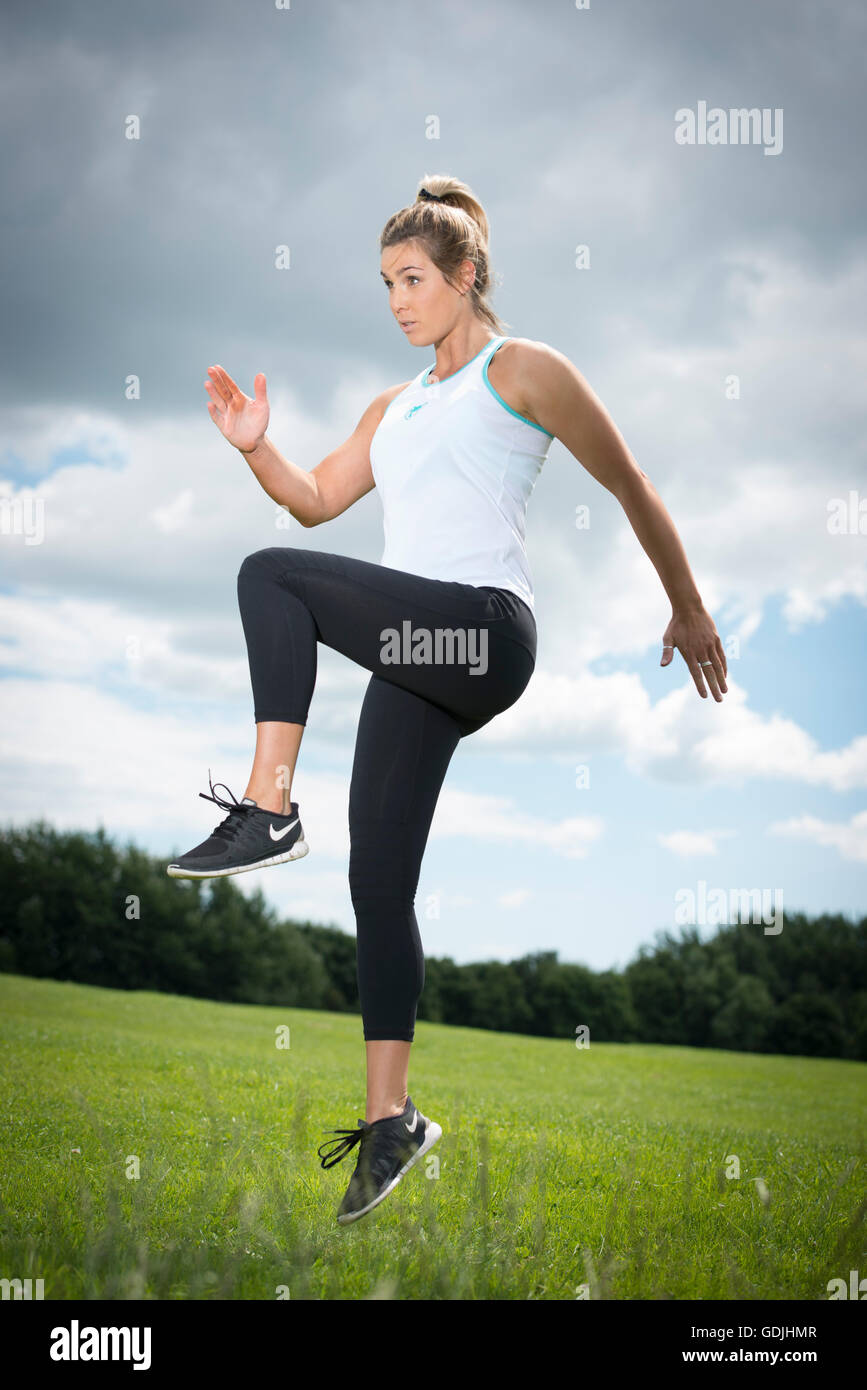 fit woman running and jumping, keeping fit Stock Photo - Alamy