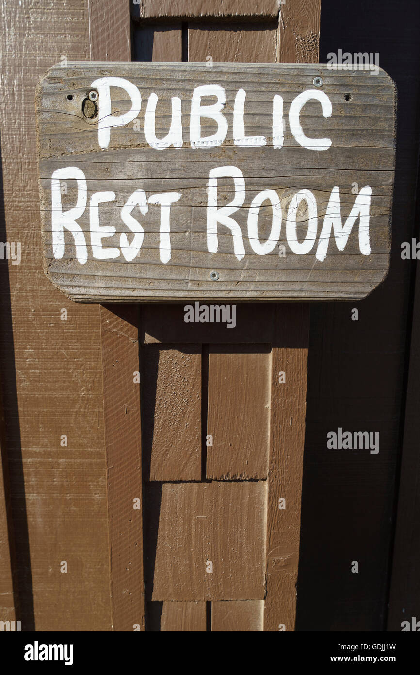 Wooden painted Public Rest Room sign nailed to a wooden wall Stock ...