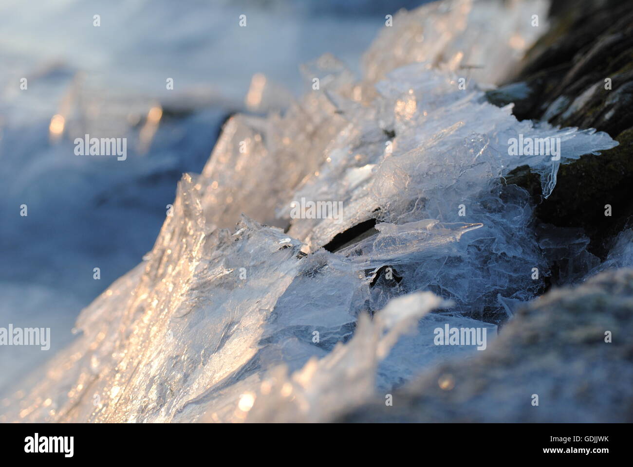 Ice crust where sea meet rocky shore. water level change and crust ...