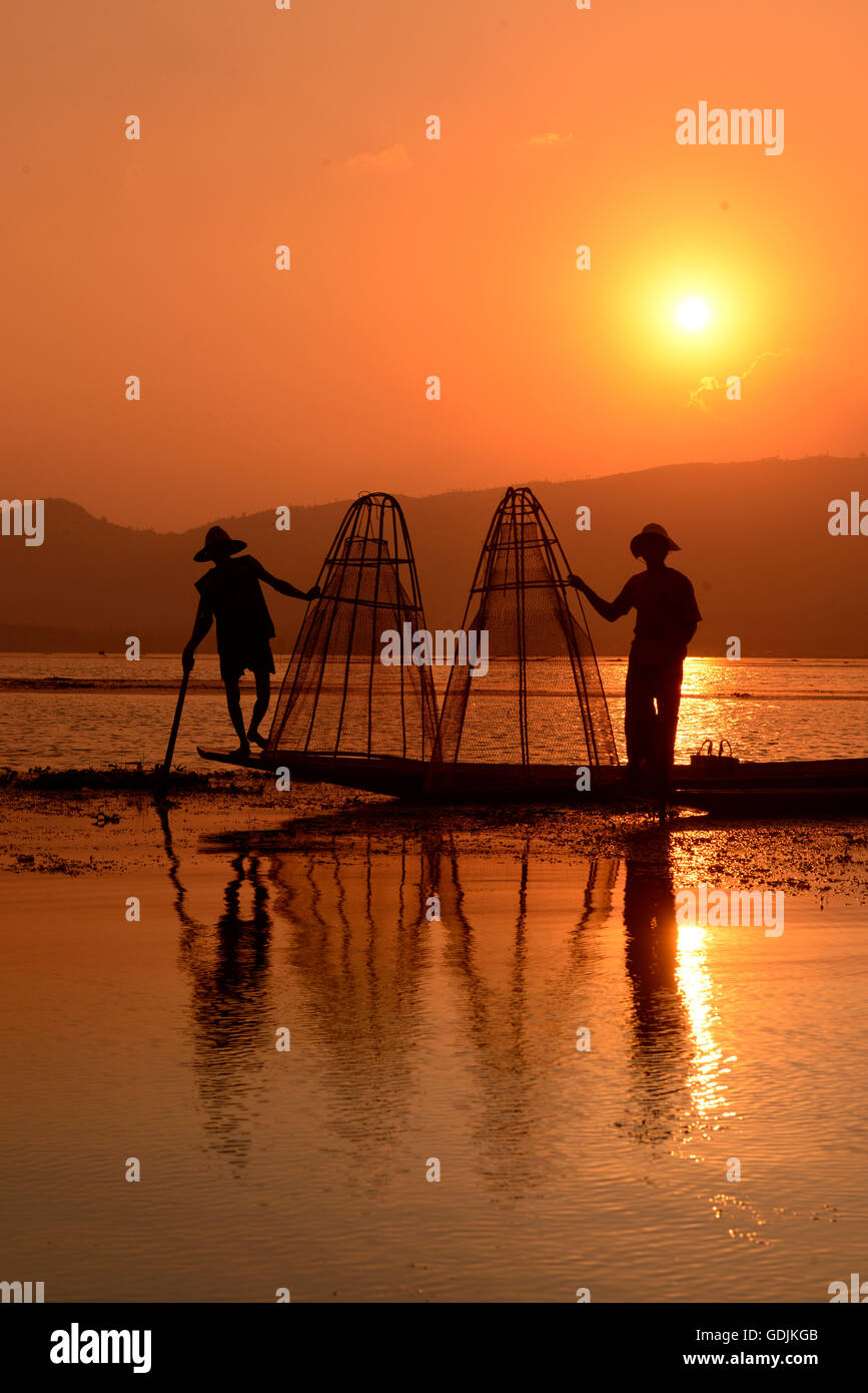 Fishermen at sunset in the Landscape on the Inle Lake in the Shan State ...