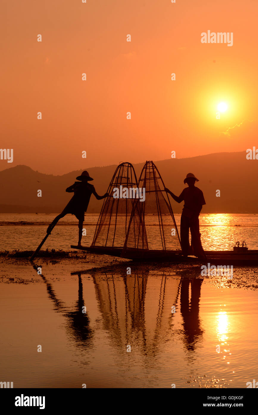 Fishermen at sunset in the Landscape on the Inle Lake in the Shan State ...