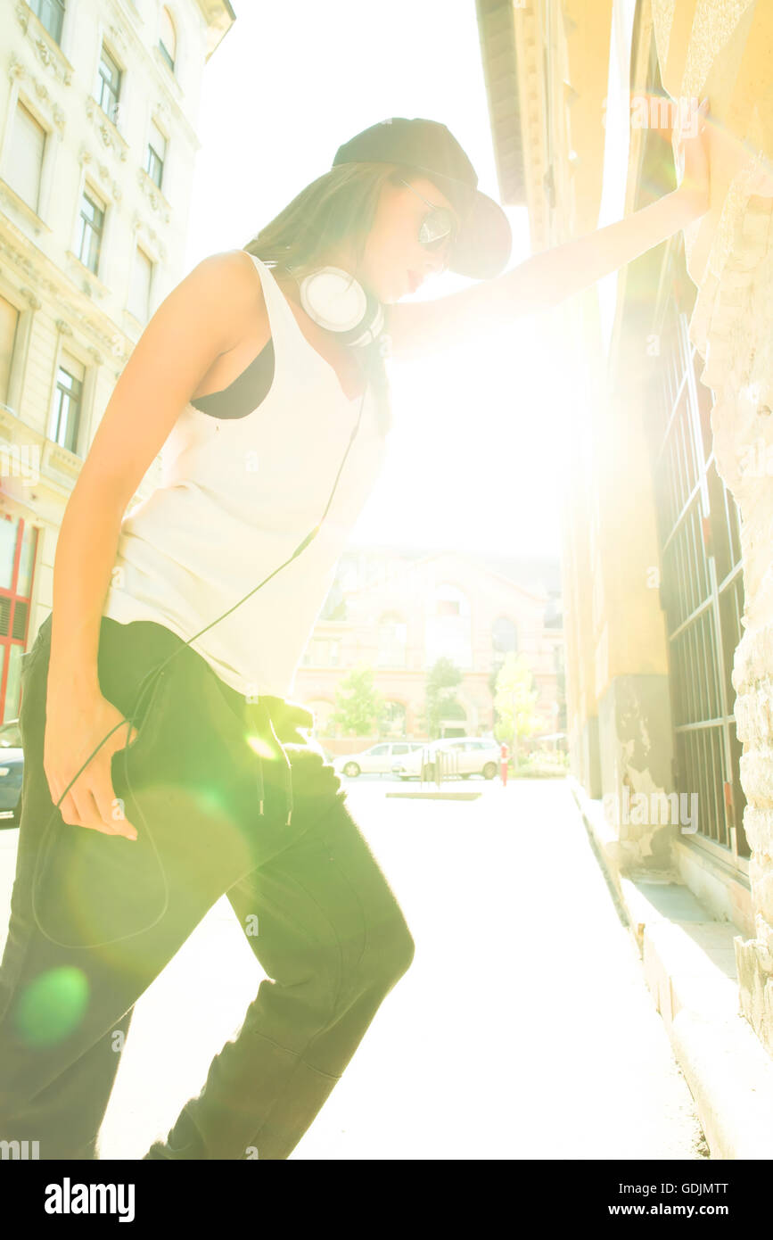 A beautiful young Hip Hop Rapper girl with Headphones in a urban ...