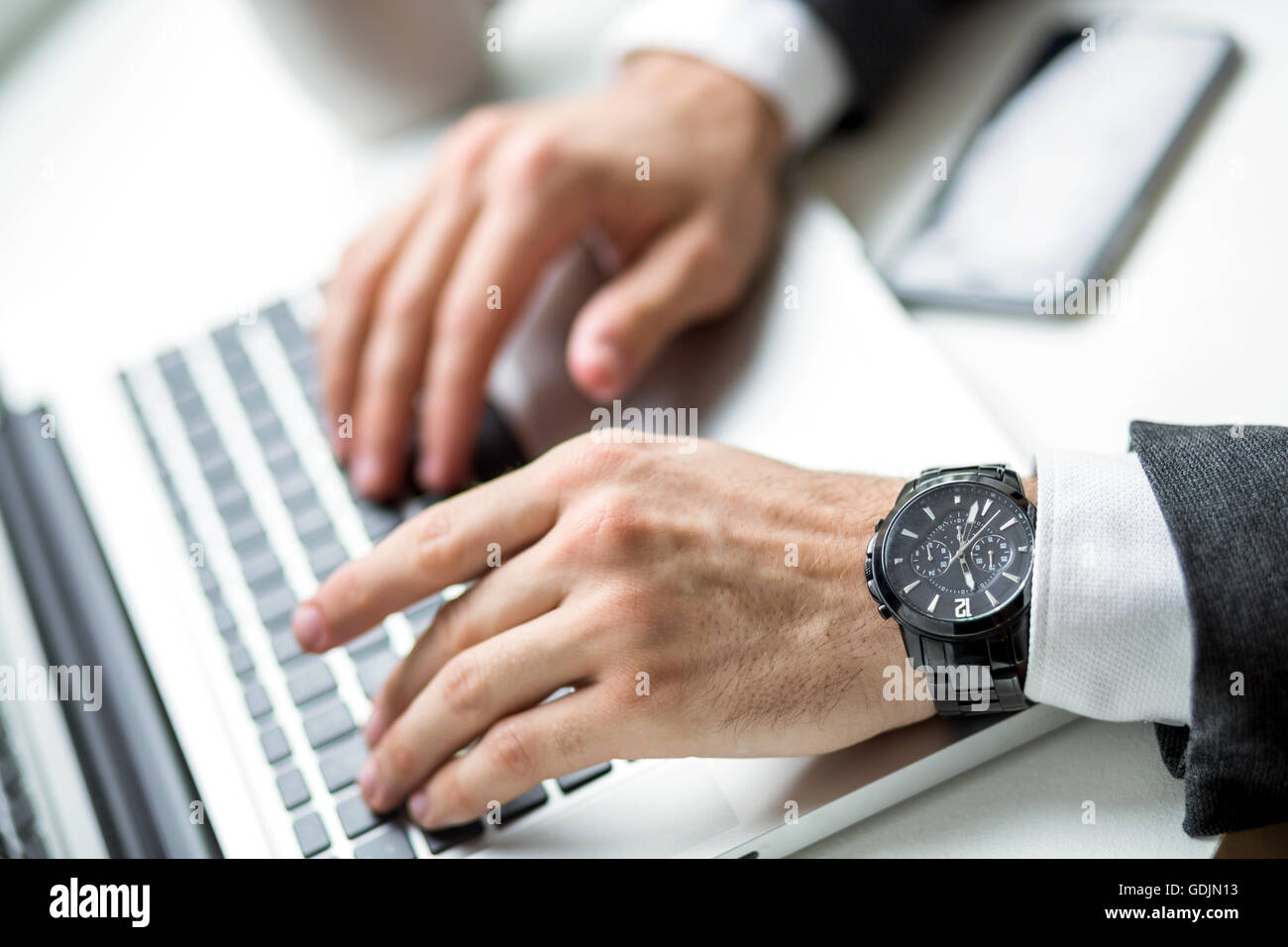 Hand of a business man while working on a laptop Stock Photo - Alamy