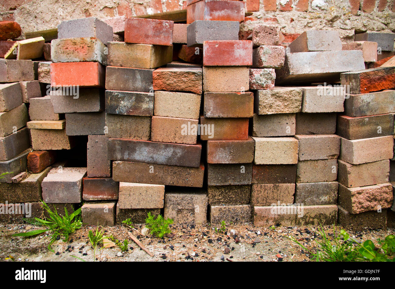 clay bricks of different color and type ready to be used to build walls ...