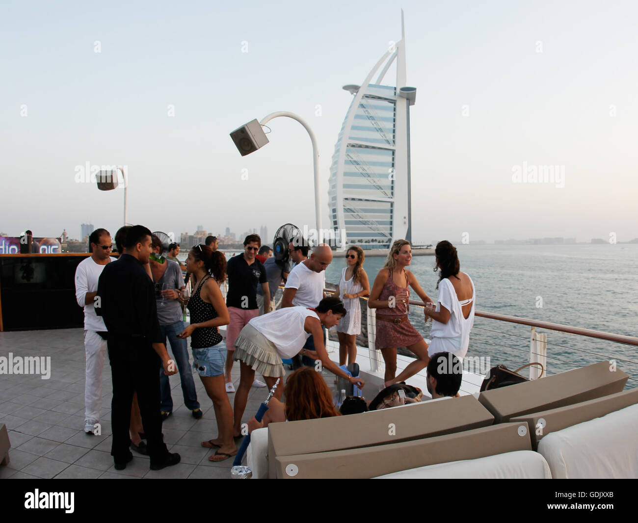 Group of friends chatting on the rooftop of 360 bar, Dubai, United arab ...